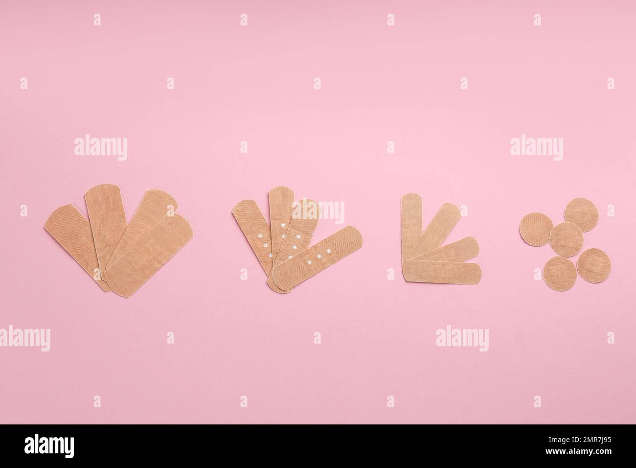 Different types of sticking plasters on pink background, flat lay Stock ...