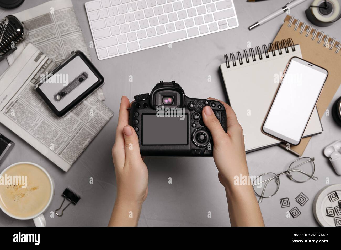 Journalist with camera at grey table, top view Stock Photo - Alamy