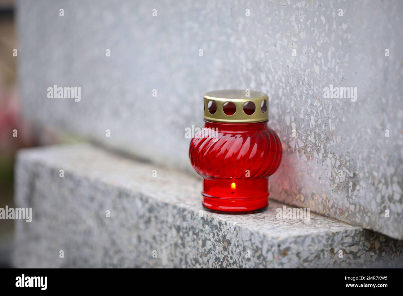 Candle on light grey granite tombstone outdoors. Funeral ceremony Stock ...