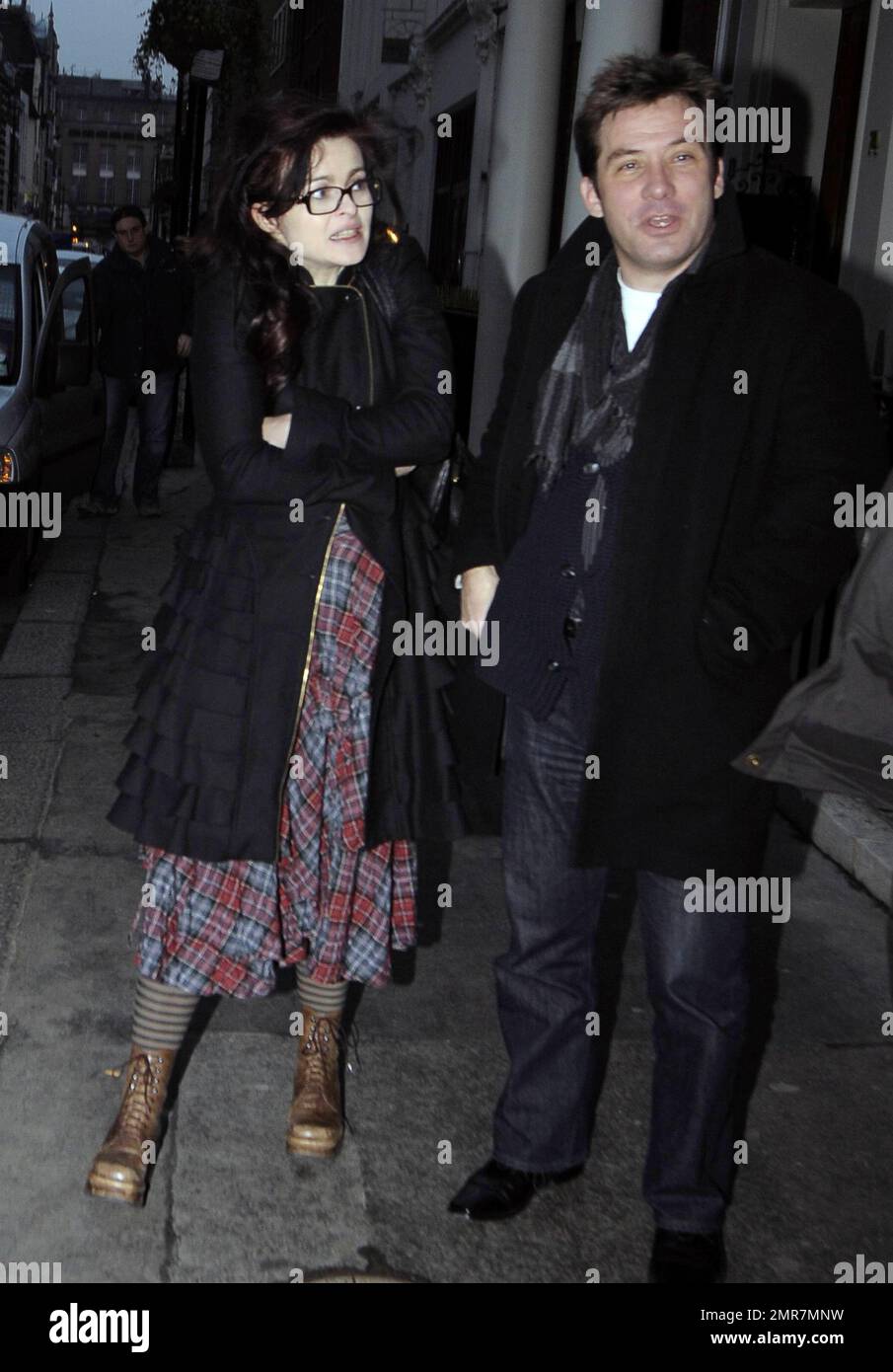 Actress Helena Bonham Carter tries to keep warm as she strolls with a ...