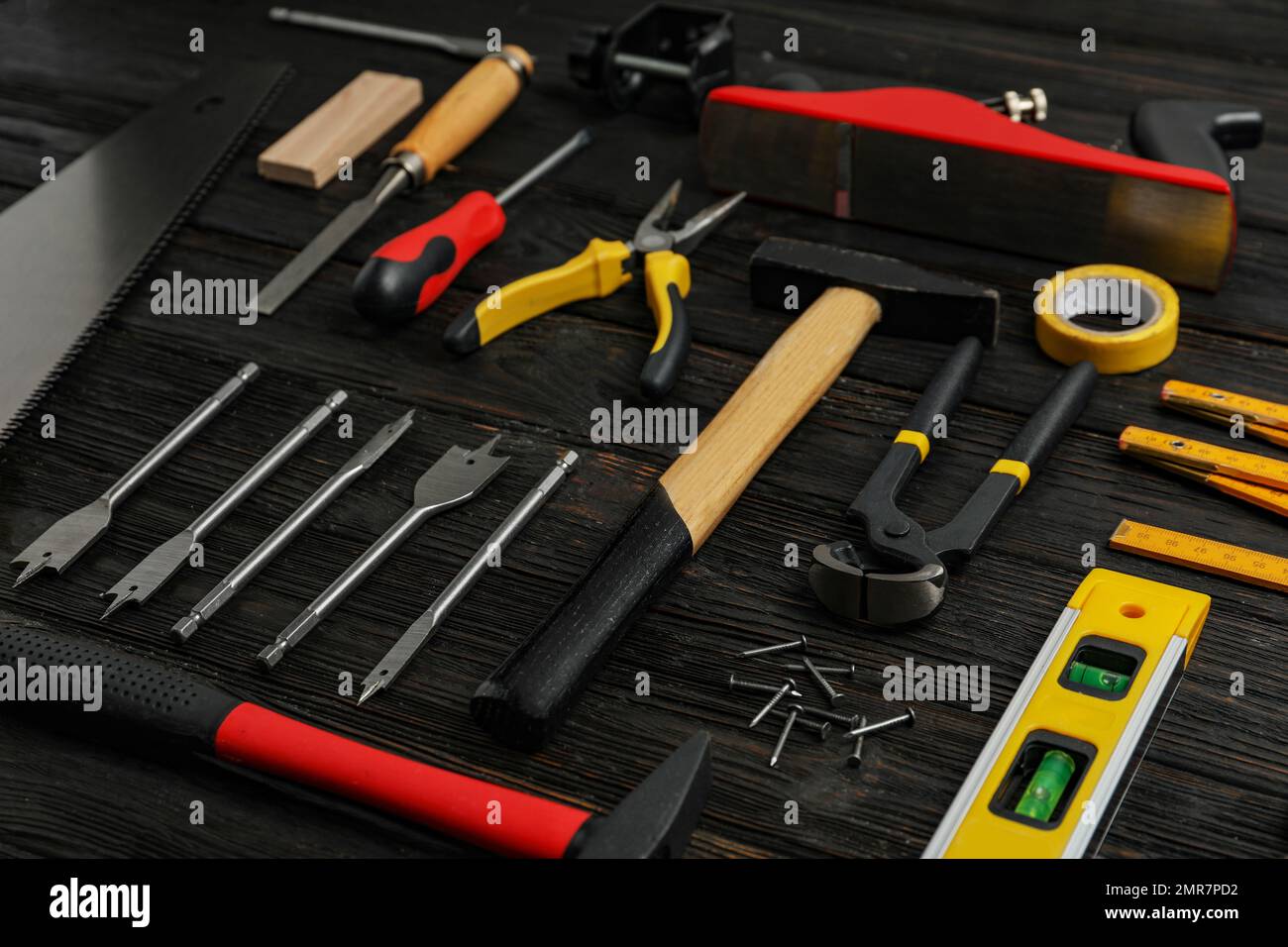 Different carpenter's tools on black wooden background Stock Photo - Alamy
