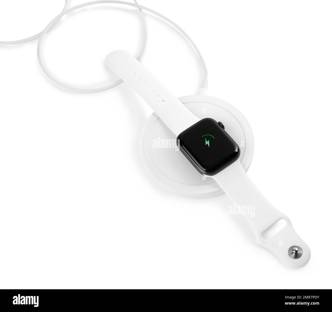 Smartwatch charging with wireless pad isolated on white, above view ...