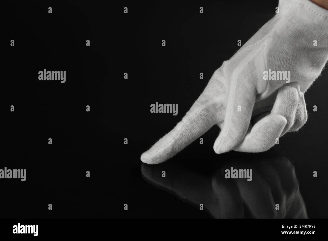 Woman checking cleanliness of black surface, closeup Stock Photo - Alamy