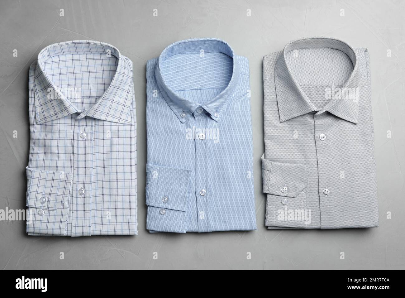 Stylish male shirts on light grey background, flat lay Stock Photo - Alamy