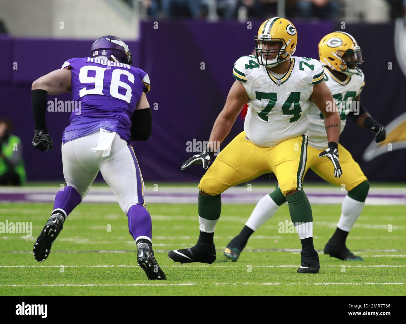Green Bay Packers offensive tackle Ulrick John (74) sets to block ...