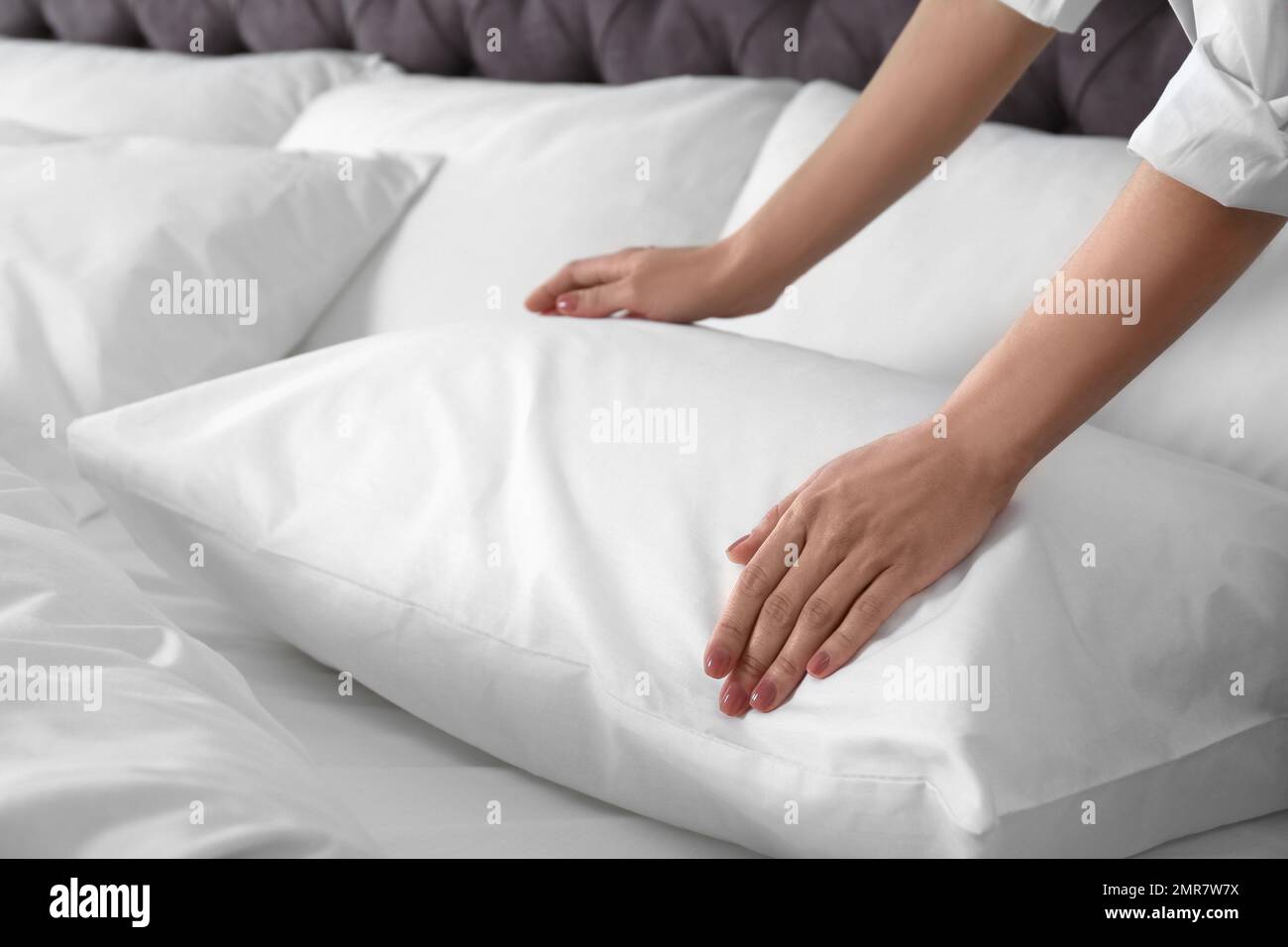 Woman fluffing soft pillow hi-res stock photography and images - Alamy