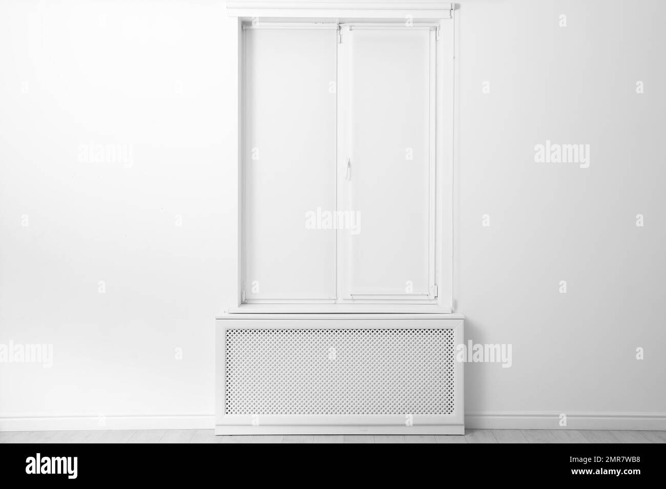 Modern window with closed Roman blinds in empty room Stock Photo - Alamy