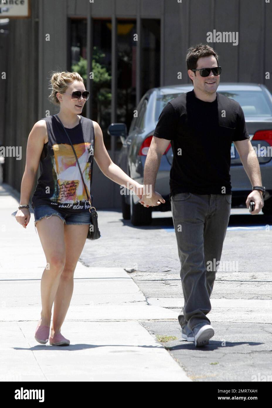 Hilary Duff wearing daisy dukes denim shorts and husband Mike Comrie ...