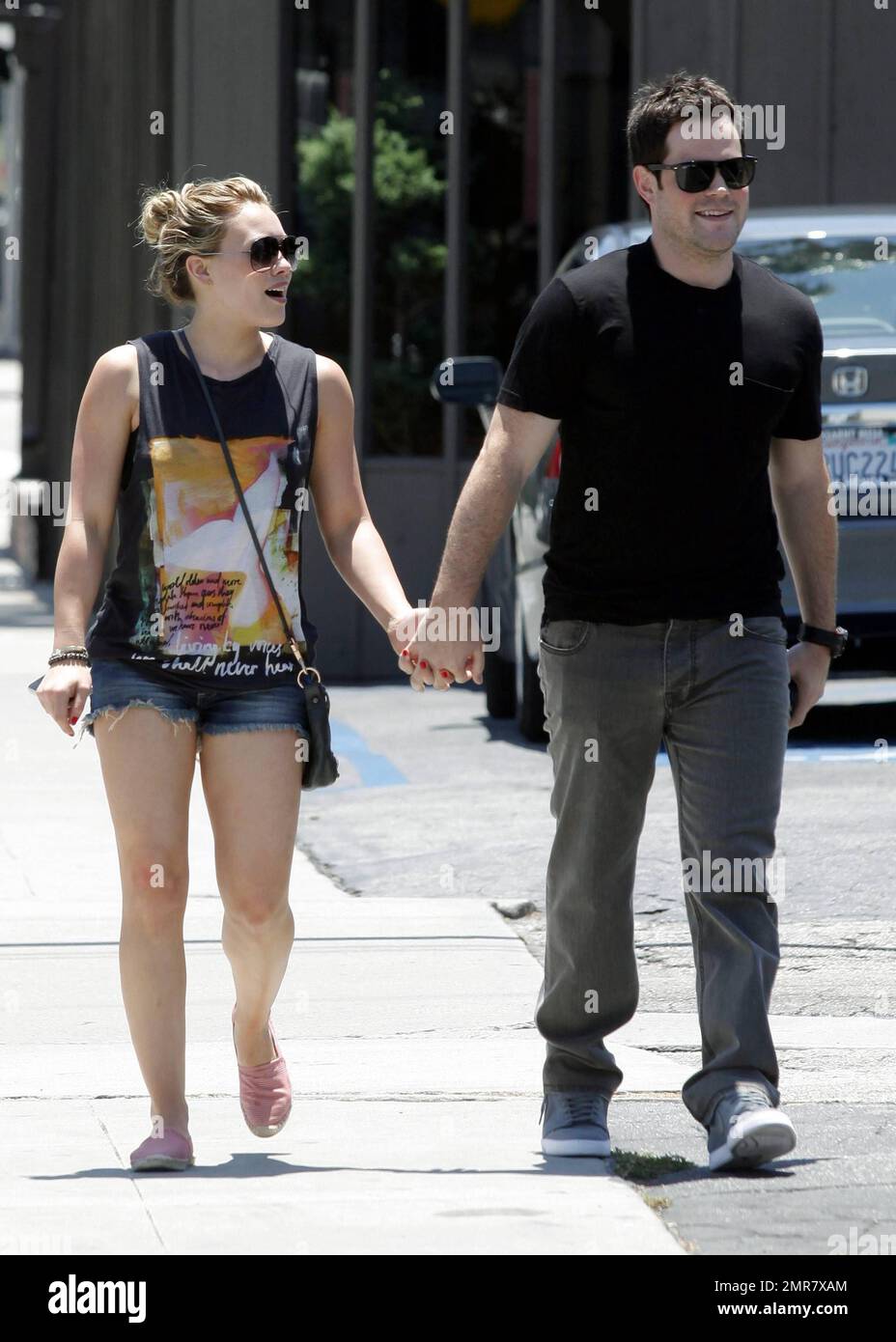 Hilary Duff wearing daisy dukes denim shorts and husband Mike Comrie ...