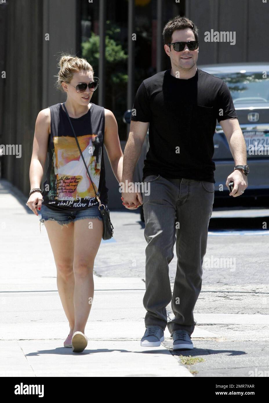 Hilary Duff wearing daisy dukes denim shorts and husband Mike Comrie ...