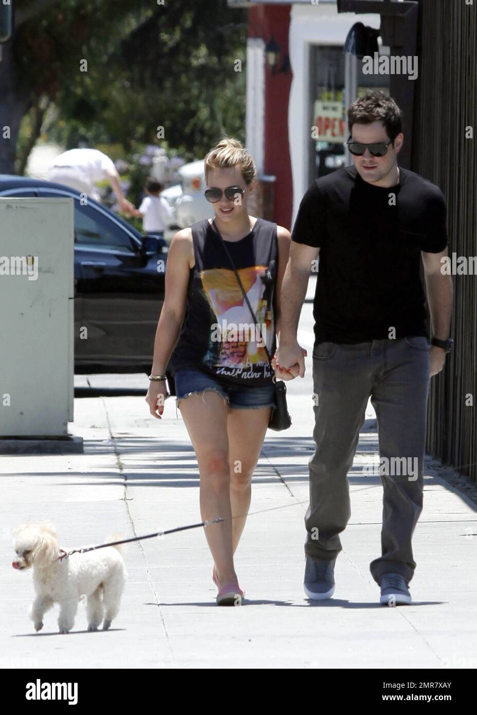Hilary Duff wearing daisy dukes denim shorts and husband Mike Comrie ...