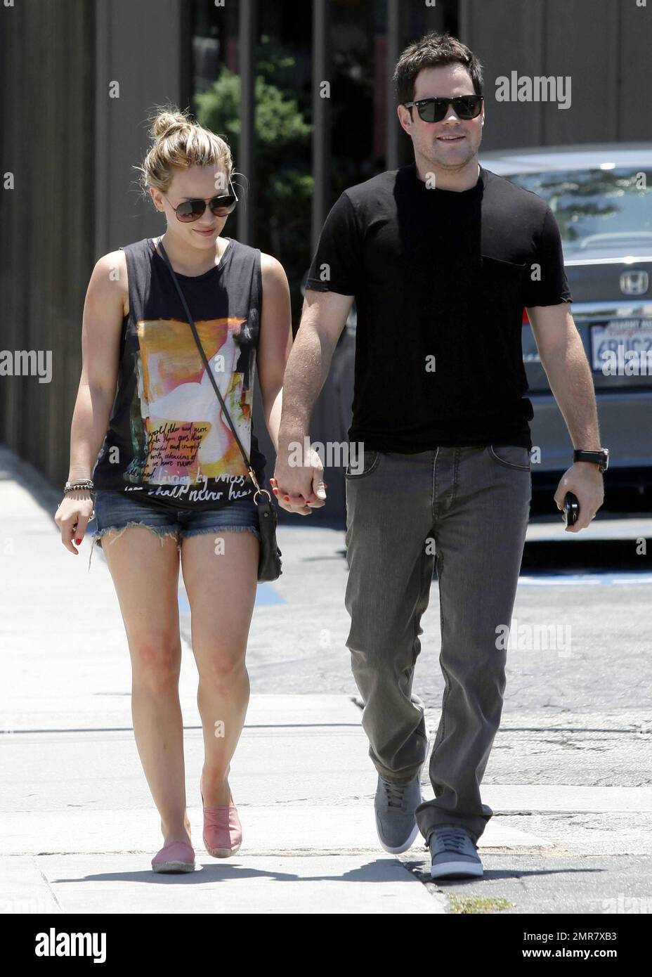 Hilary Duff wearing daisy dukes denim shorts and husband Mike Comrie ...
