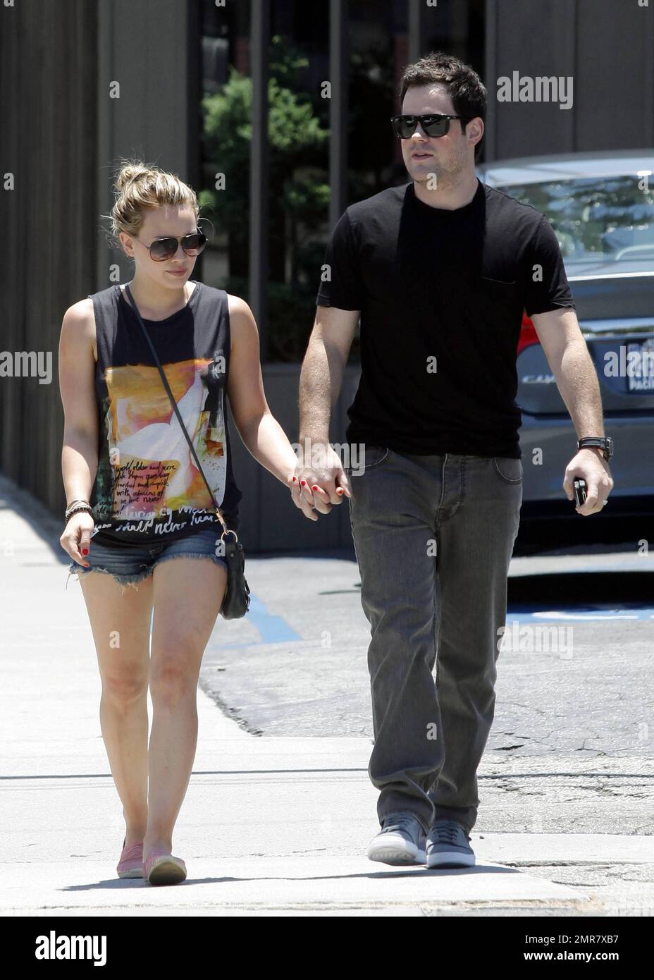 Hilary Duff wearing daisy dukes denim shorts and husband Mike Comrie ...