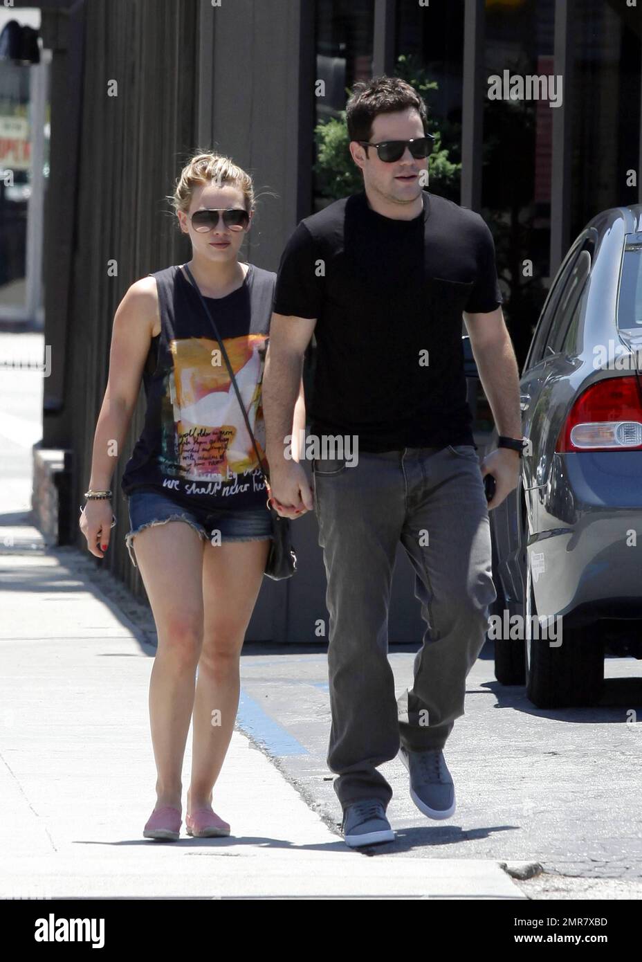 Hilary Duff wearing daisy dukes denim shorts and husband Mike Comrie ...