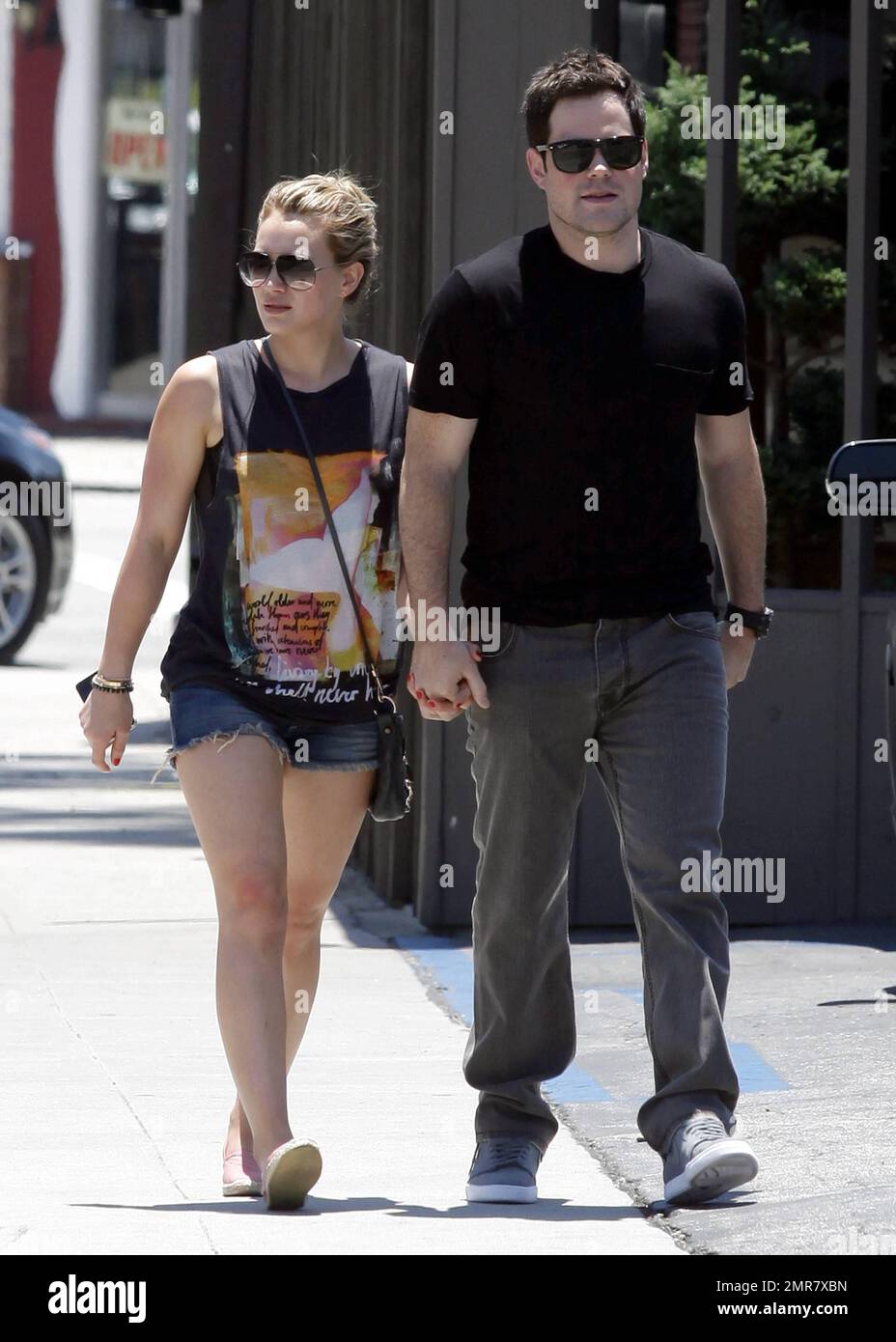 Hilary Duff wearing daisy dukes denim shorts and husband Mike Comrie ...