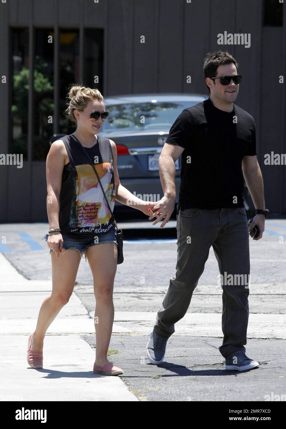 Hilary Duff wearing daisy dukes denim shorts and husband Mike Comrie ...