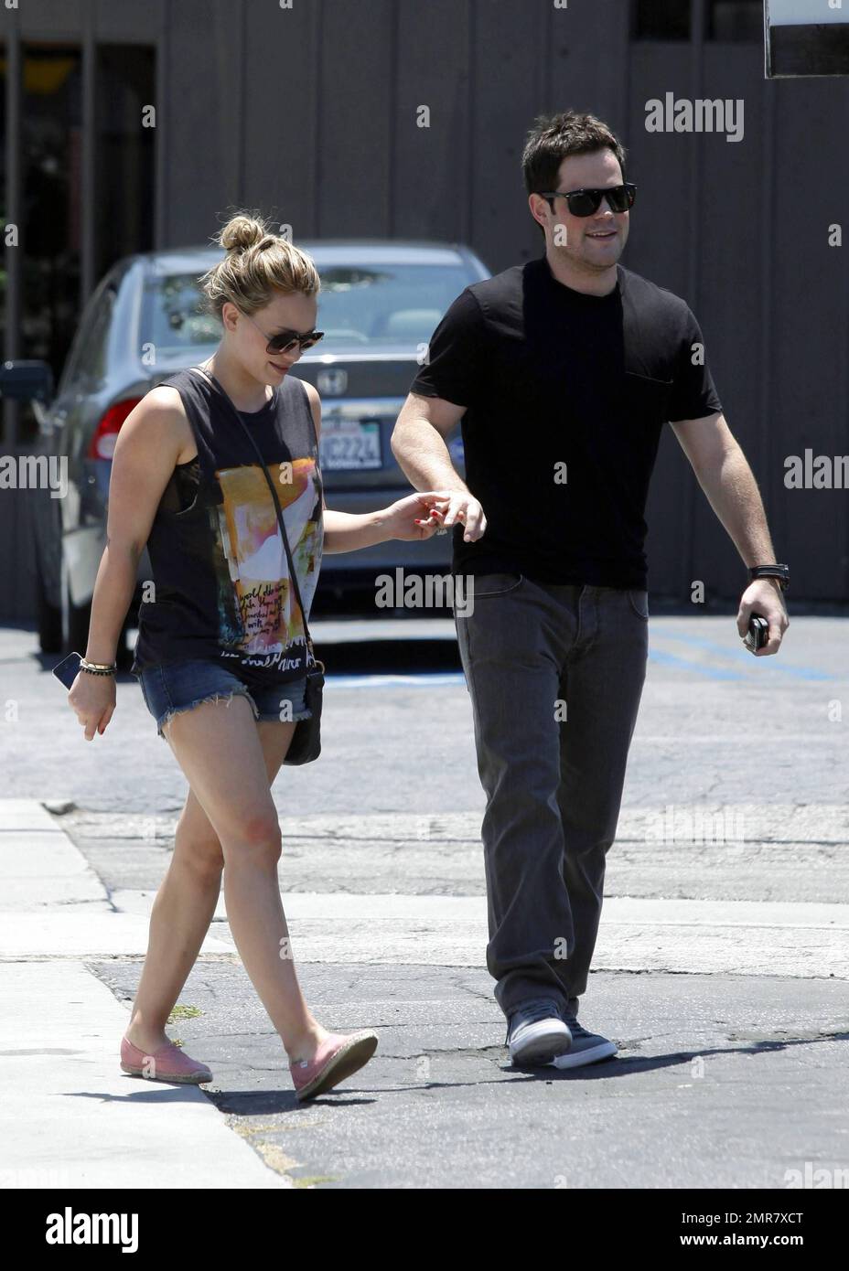 Hilary Duff wearing daisy dukes denim shorts and husband Mike Comrie ...