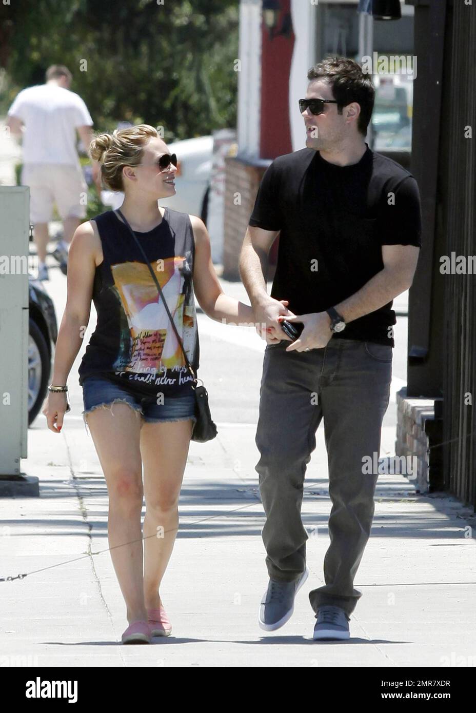Hilary Duff wearing daisy dukes denim shorts and husband Mike Comrie ...