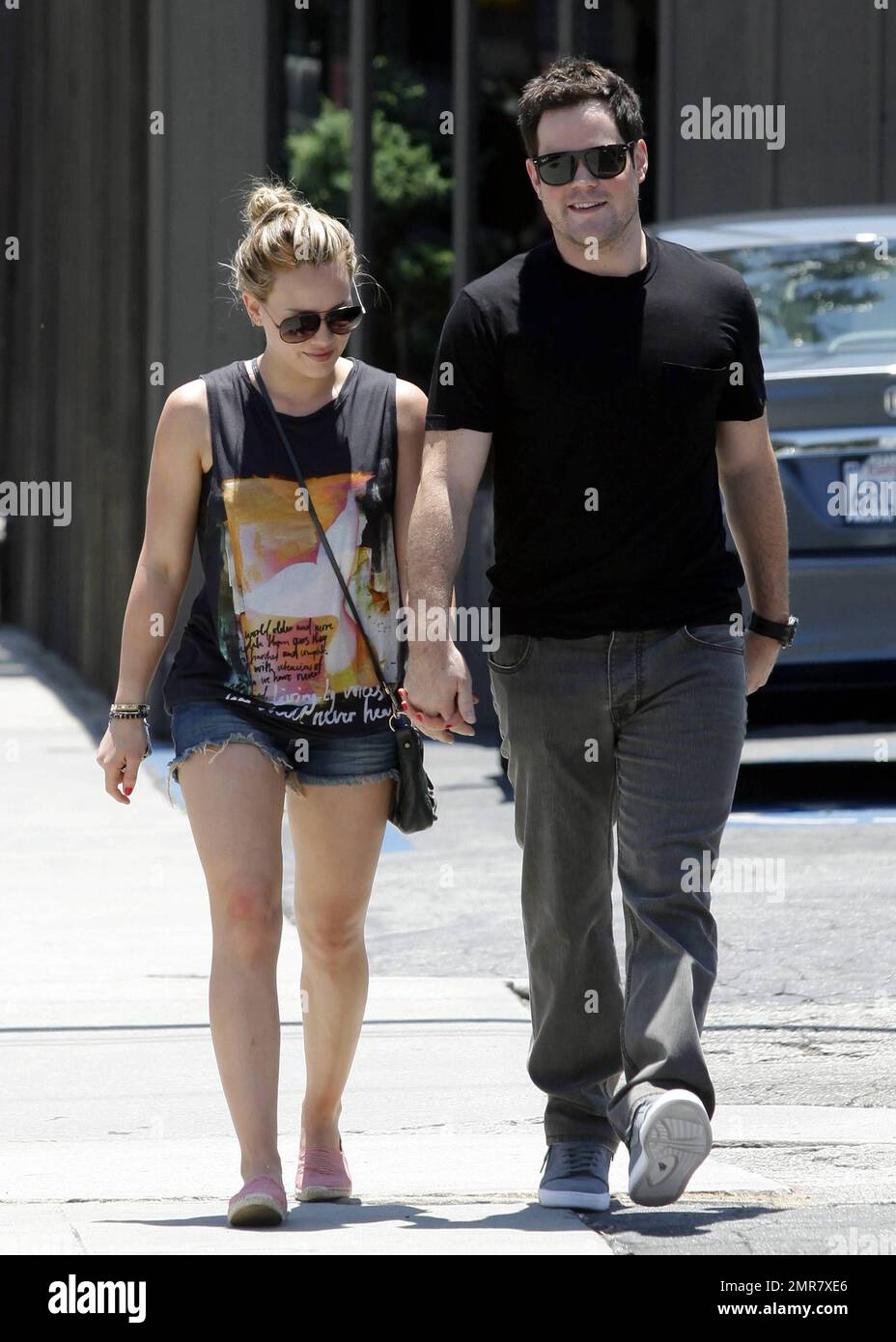Hilary Duff wearing daisy dukes denim shorts and husband Mike Comrie ...