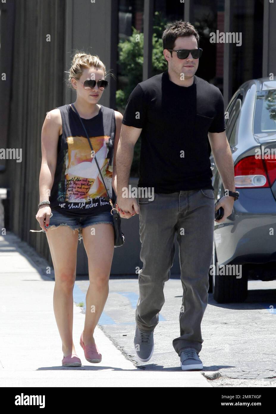 Hilary Duff wearing daisy dukes denim shorts and husband Mike Comrie ...