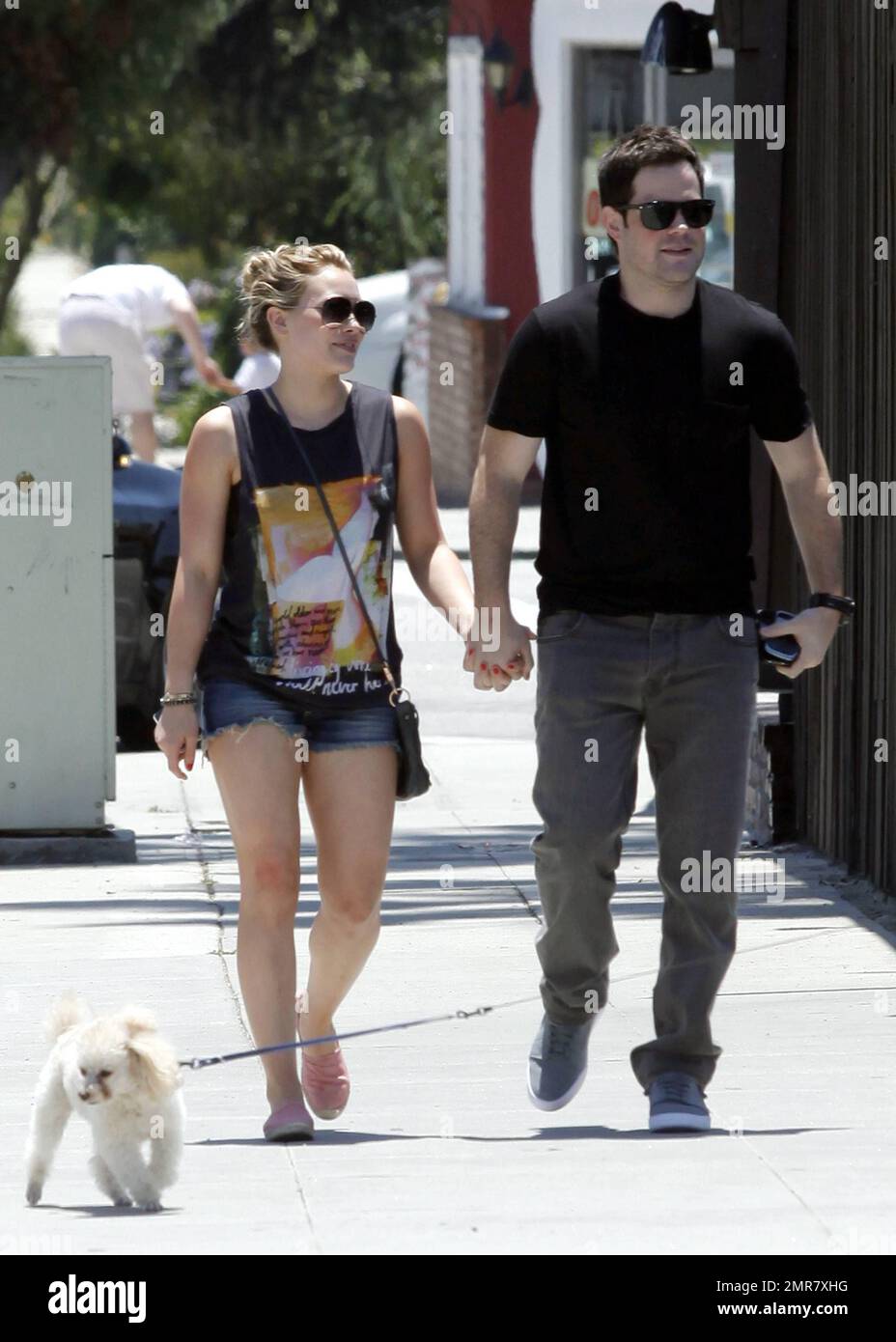 Hilary Duff wearing daisy dukes denim shorts and husband Mike Comrie ...