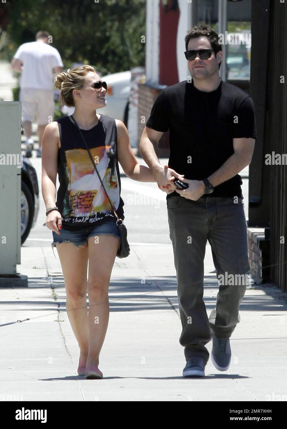 Hilary Duff wearing daisy dukes denim shorts and husband Mike Comrie ...