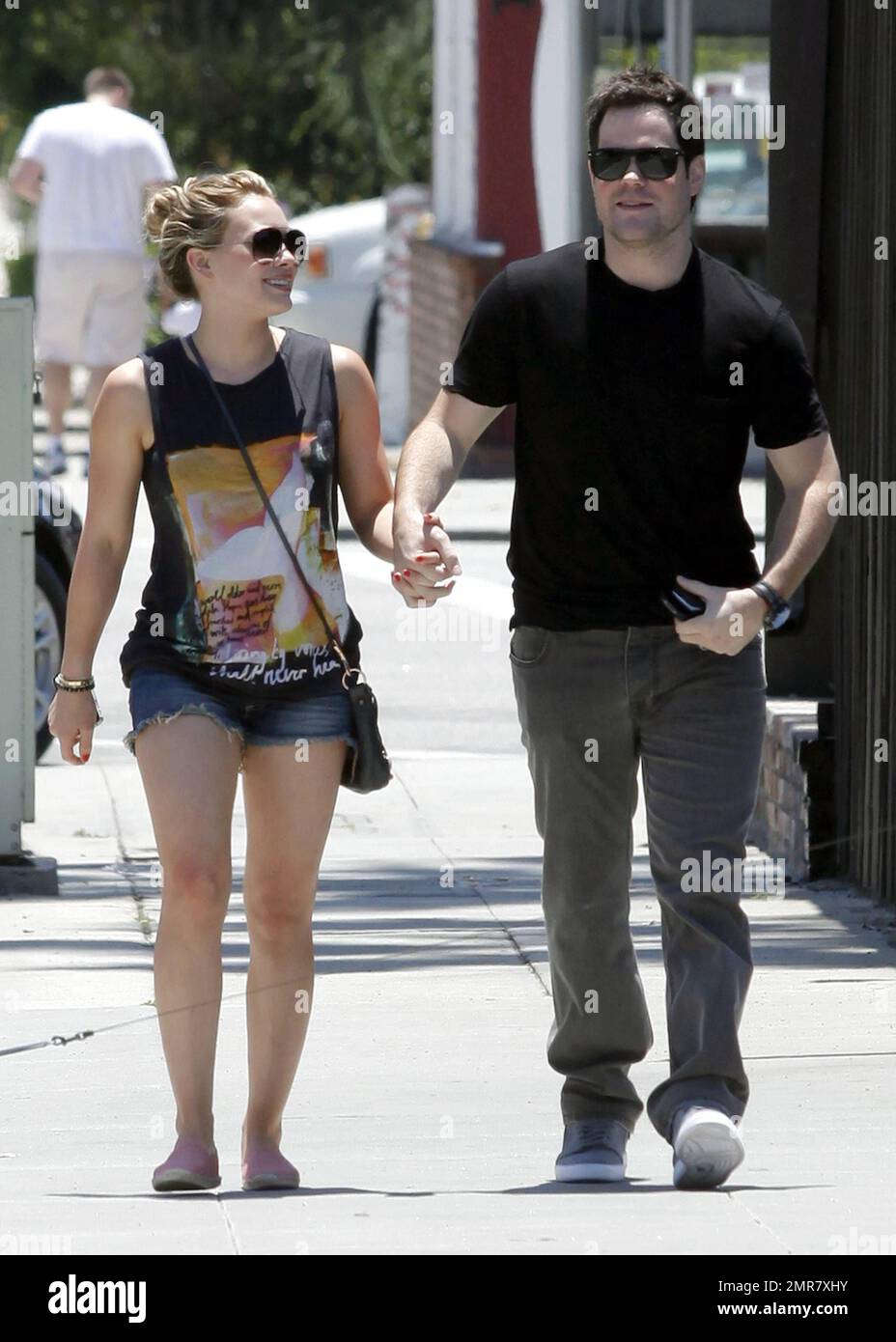 Hilary Duff wearing daisy dukes denim shorts and husband Mike Comrie ...