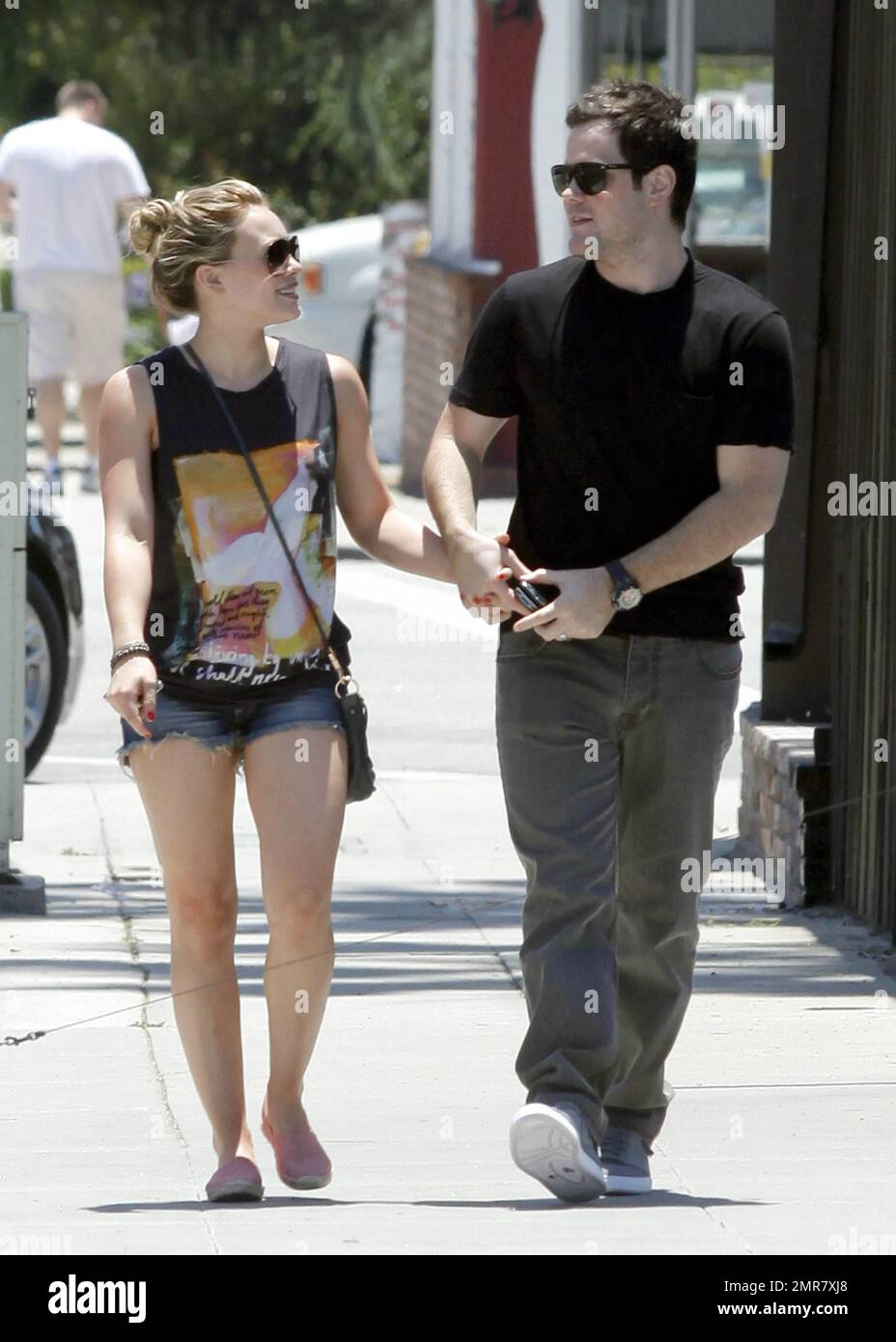 Hilary Duff wearing daisy dukes denim shorts and husband Mike Comrie ...