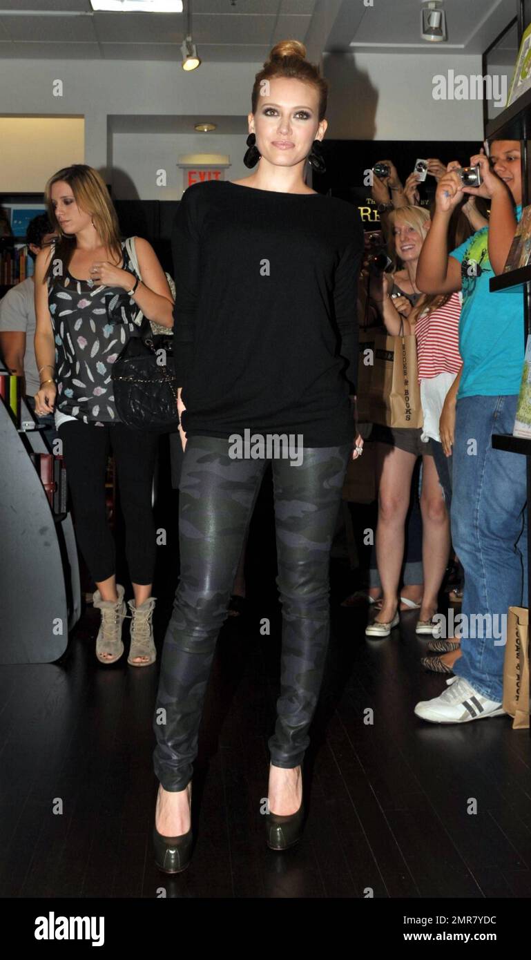 Wearing a black top and camouflage patterned leather pants, actress ...