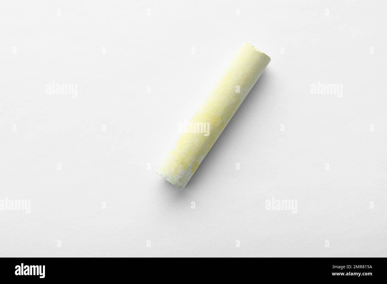 Small piece of yellow chalk isolated on white, top view Stock Photo - Alamy