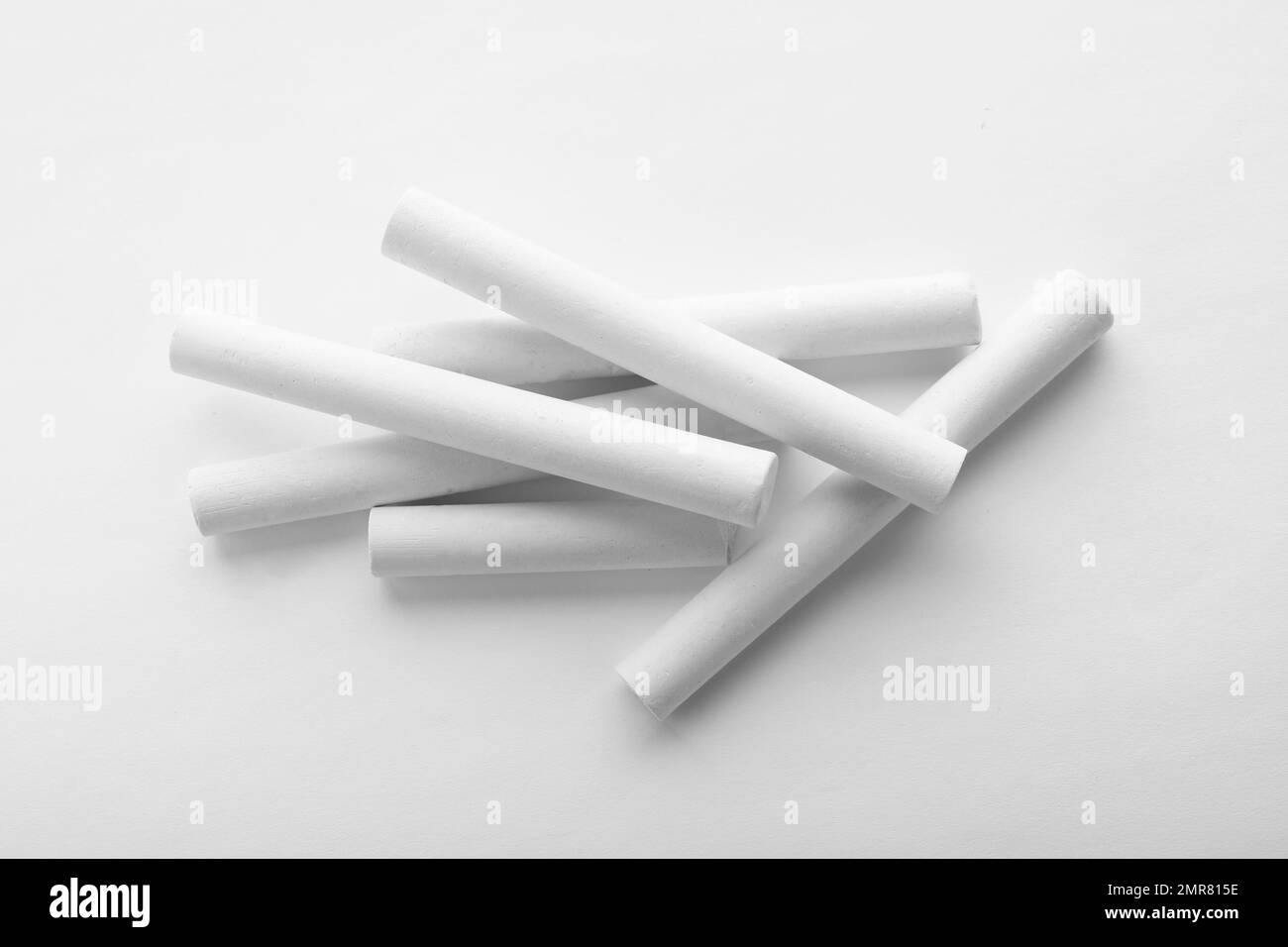 Pieces of chalk on white background, top view Stock Photo - Alamy