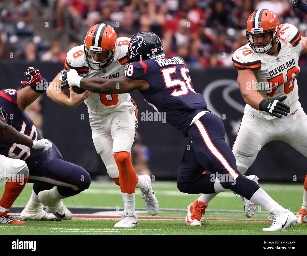 Cleveland Browns quarterback Kevin Hogan attempts to escape the grasp ...