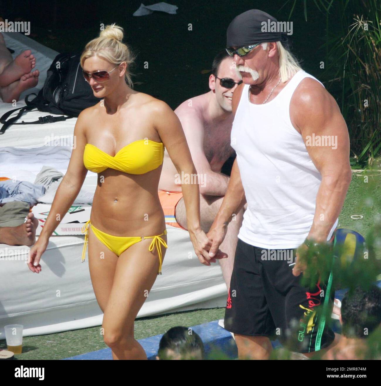 Exclusive!! Hulk Hogan's girlfriend Jennifer McDaniel soaks up the sun poolside in a bright ...