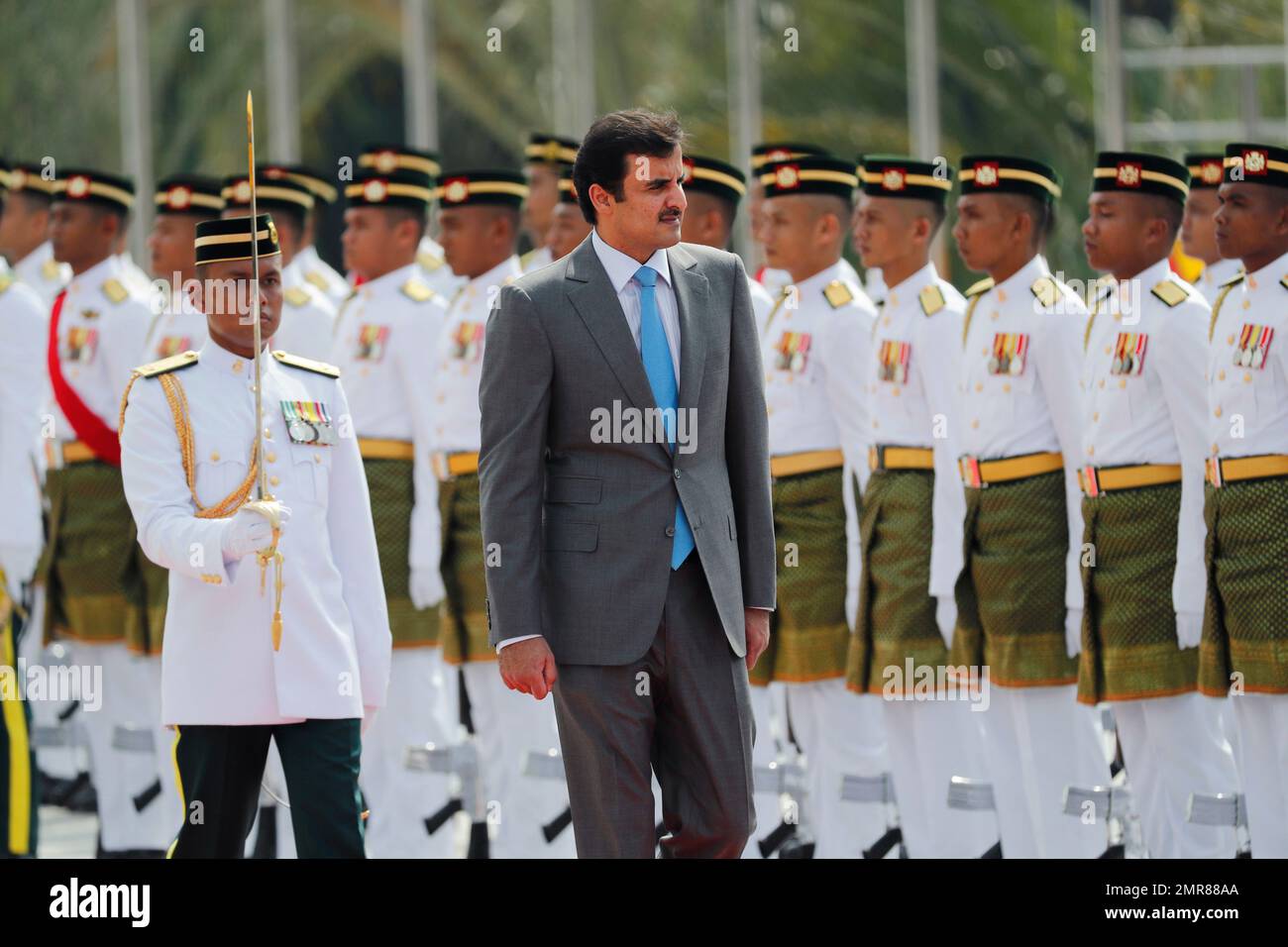 Qatar's Emir Sheikh Tamim bin Hamad Al Thani, center, inspects an honor ...