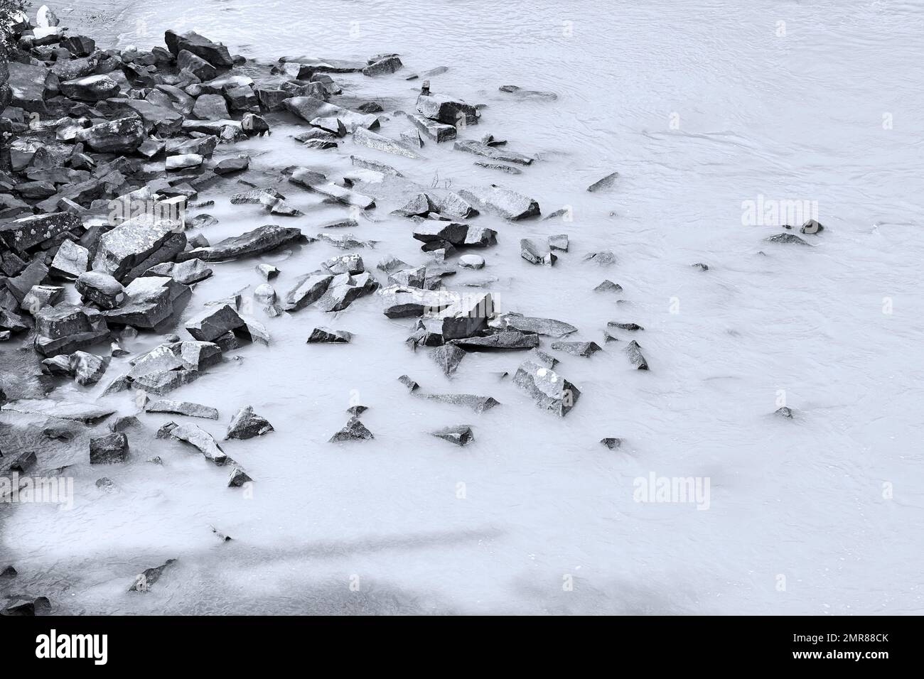 This image features a cool, natural scene of rocks and water on a ...