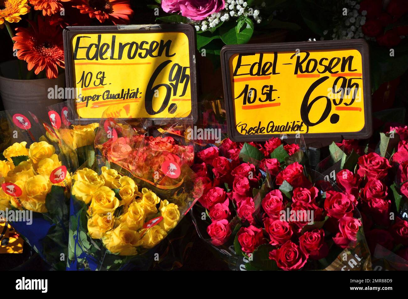 Several bouquets of yellow and red roses at street stall, Munich ...