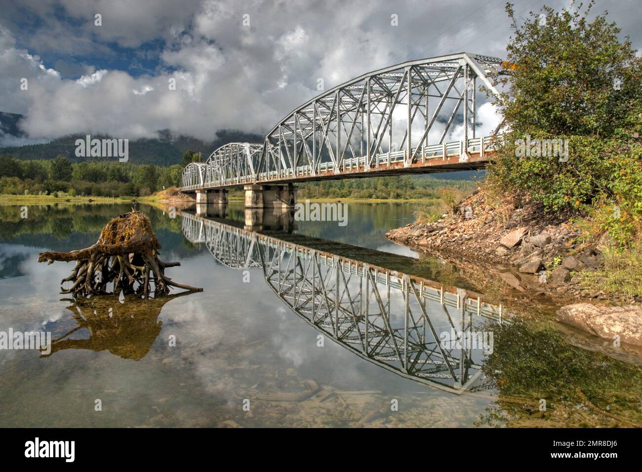 A scene of the Nisutlin Bay Bridge reflected on the water surrounded by ...