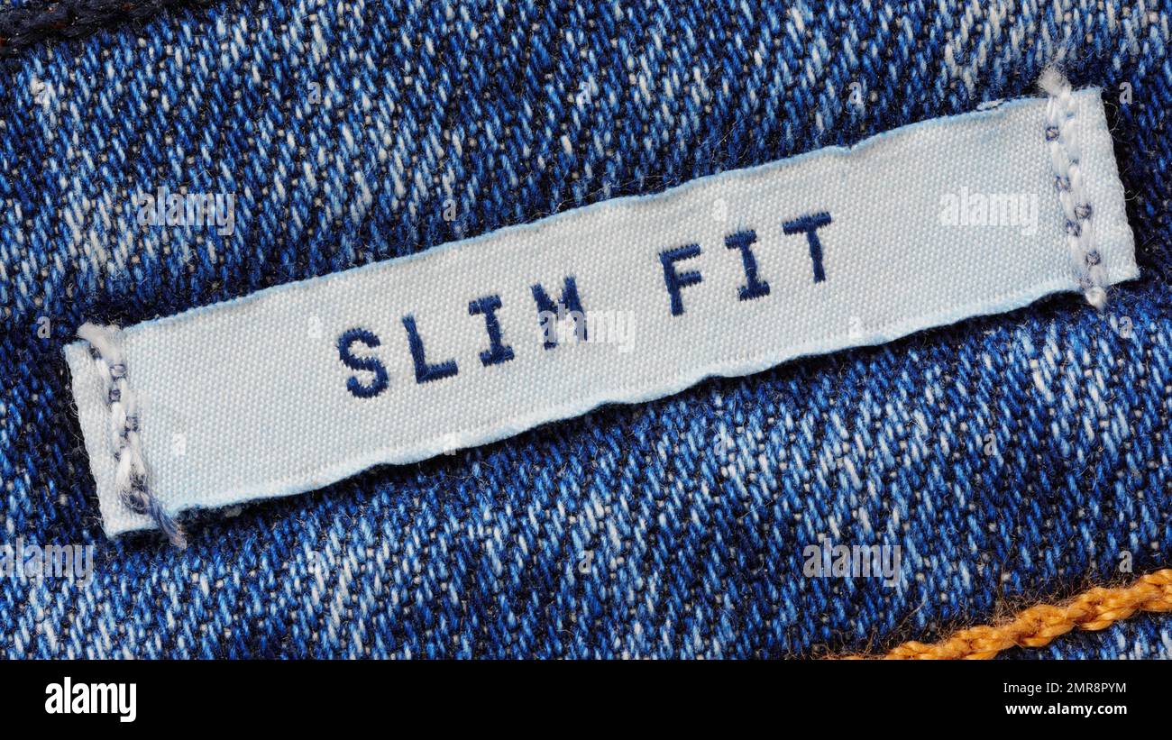 Close-up of textile label with the inscription Slim Fit Stock Photo - Alamy
