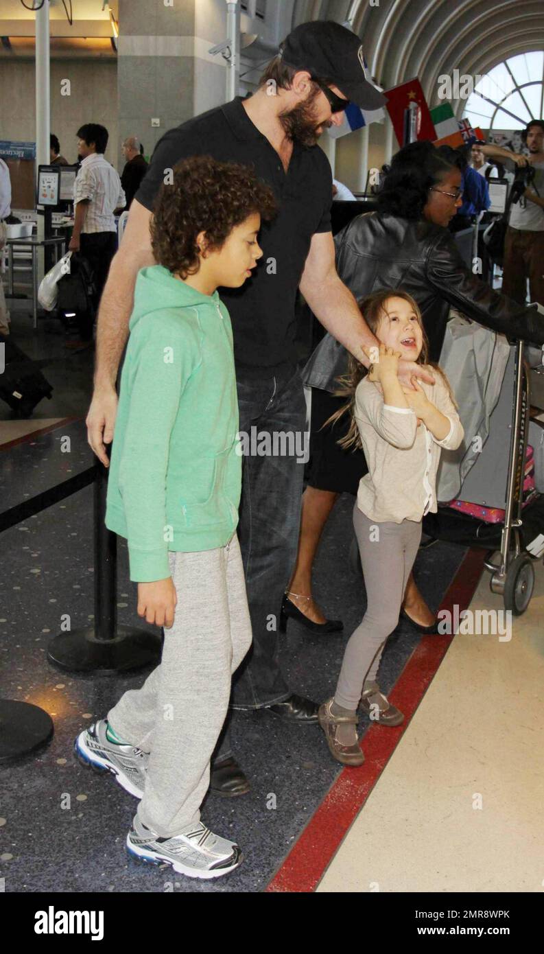 A bearded Hugh Jackman arrives at LAX on a flight from New York with ...