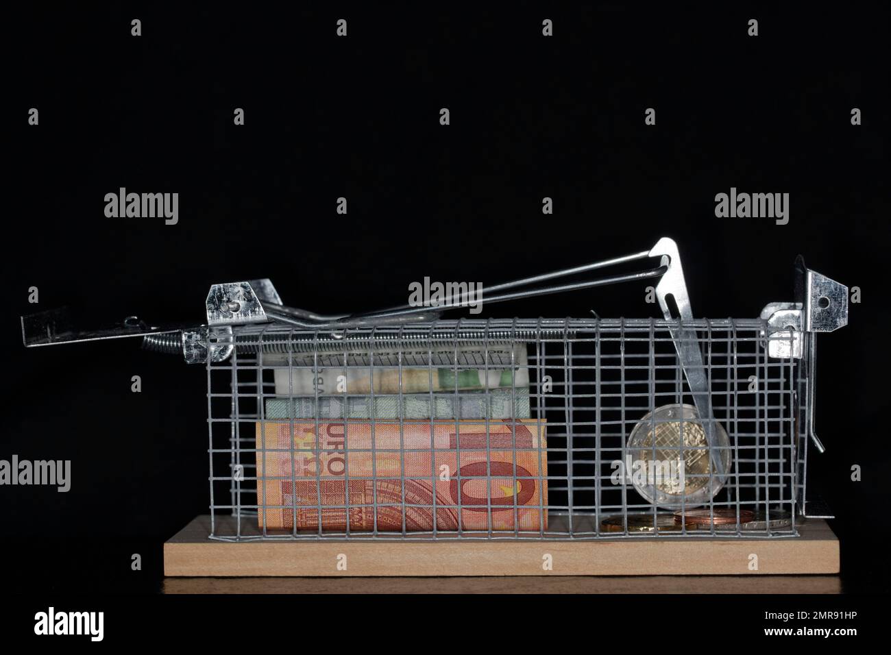Euro coins and paper money lying in a live trap for mice, symbol photo ...
