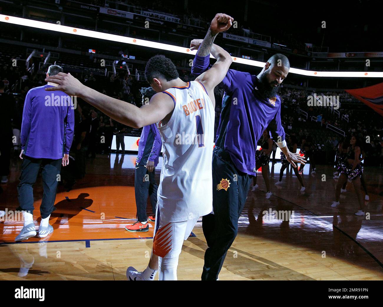 Phoenix Suns guard Devin Booker (1) welcomes teammate Tyson Chandler to ...