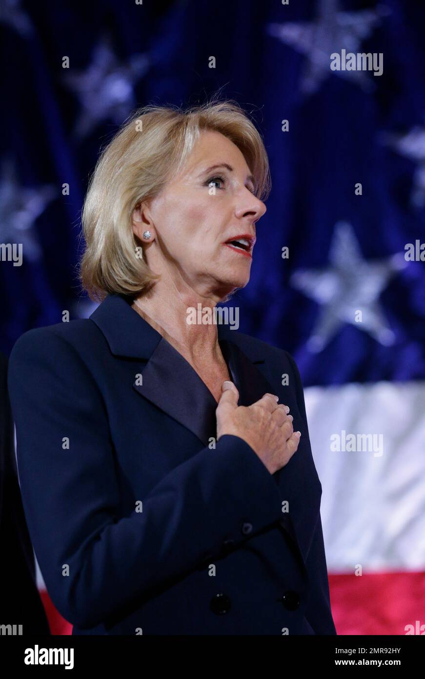 U.S. Education Secretary Betsy DeVos stands during the singing of the ...