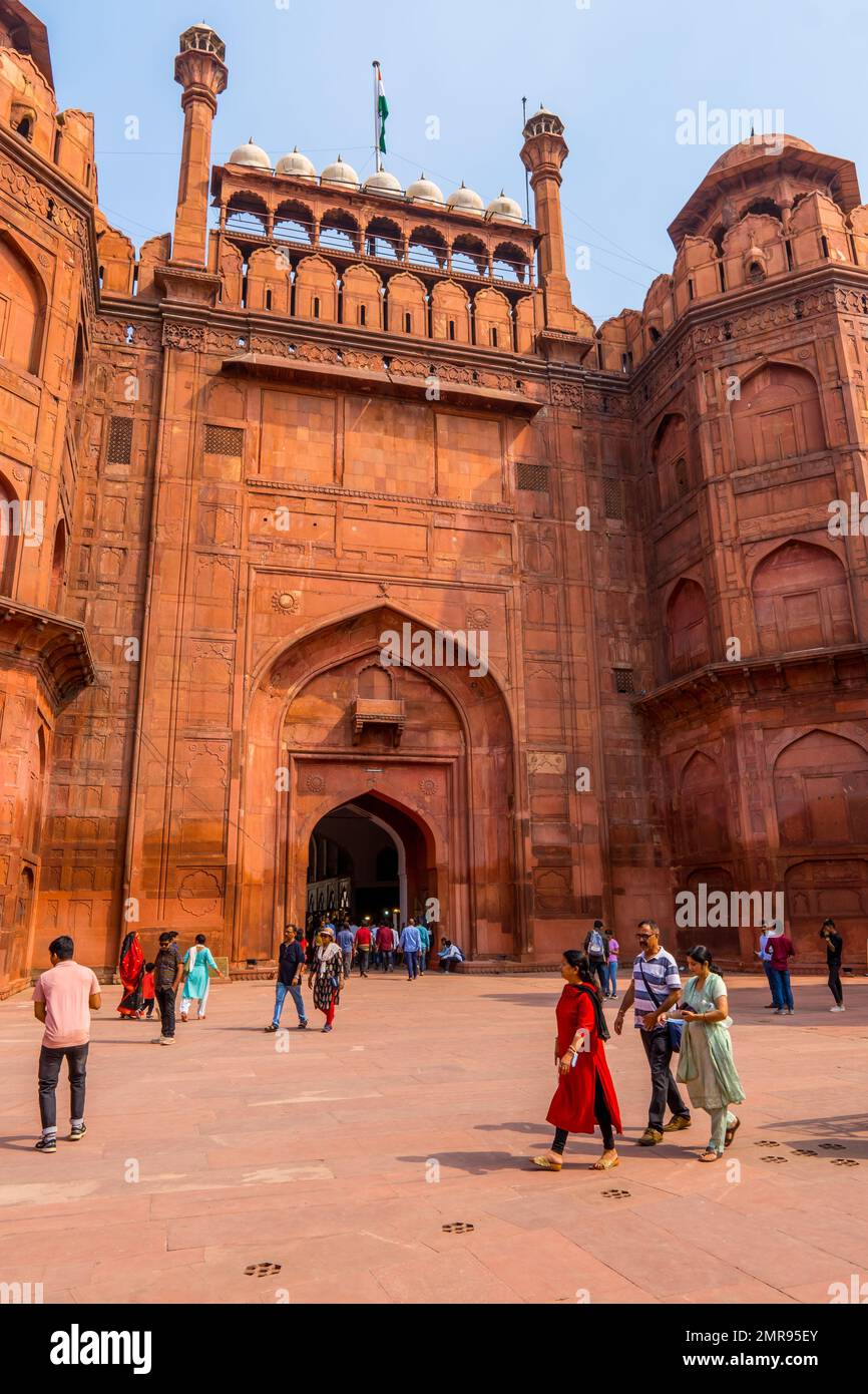 A vertical shot of tourists and ancient buildings inside the Red Fort ...