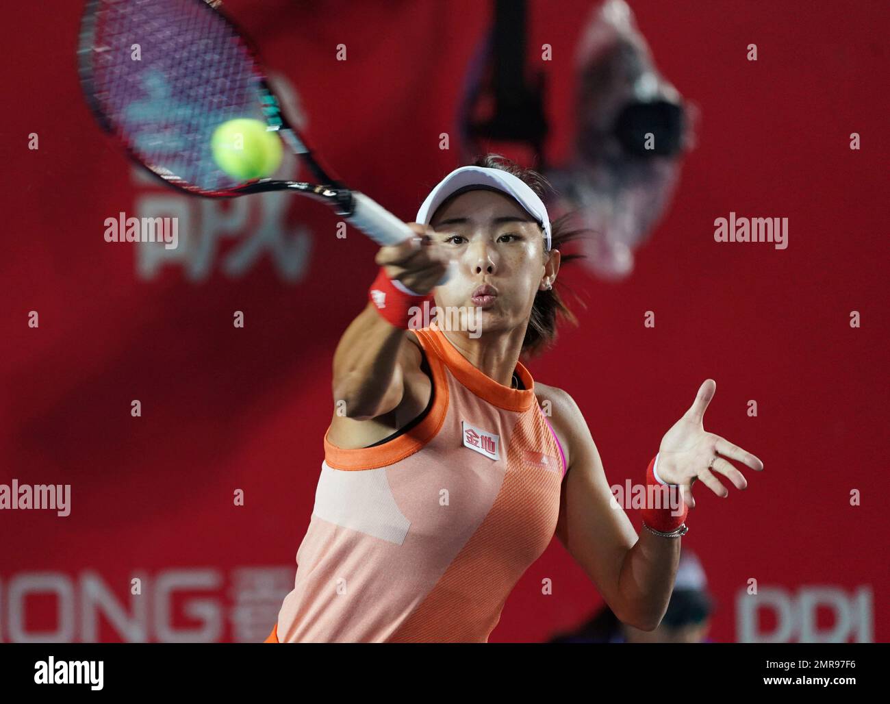 Wang Qiang of China returns a shot to Samantha Stosur of Australia during the quarter-final ...