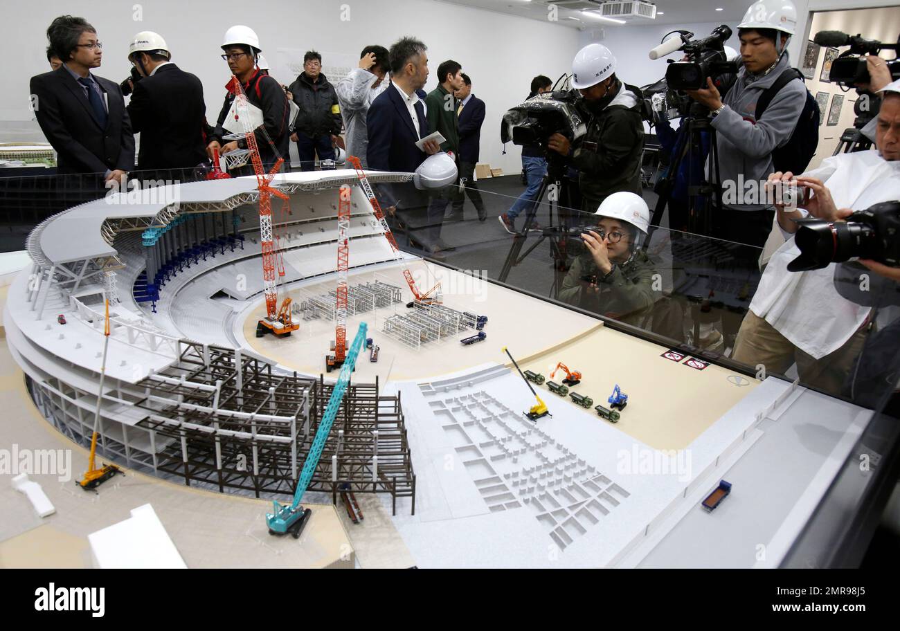 Photographers take a photo of the 1/150 scale model of the new national ...