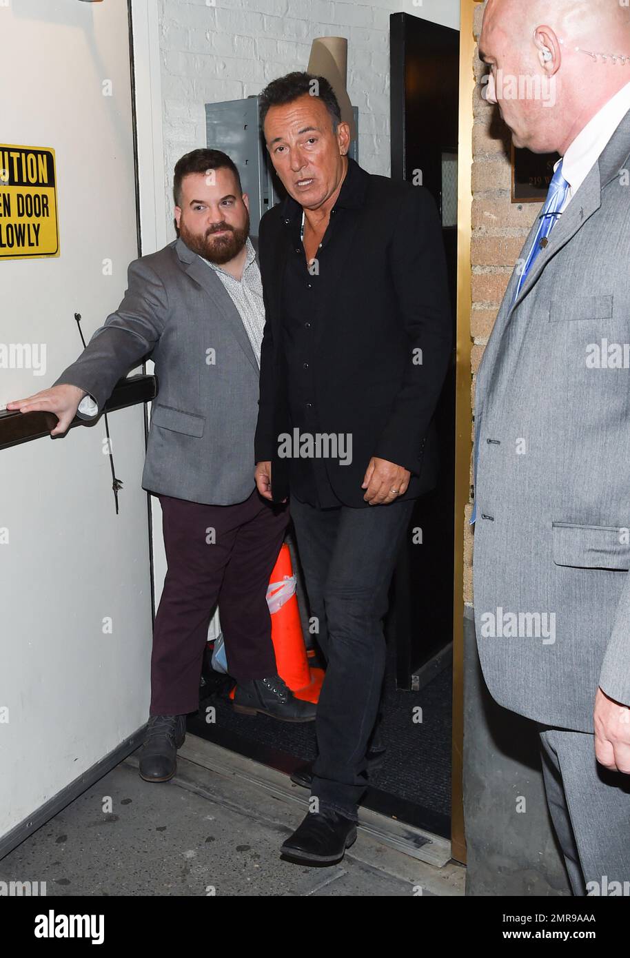 Musician Bruce Springsteen exits out the stage door after the ...