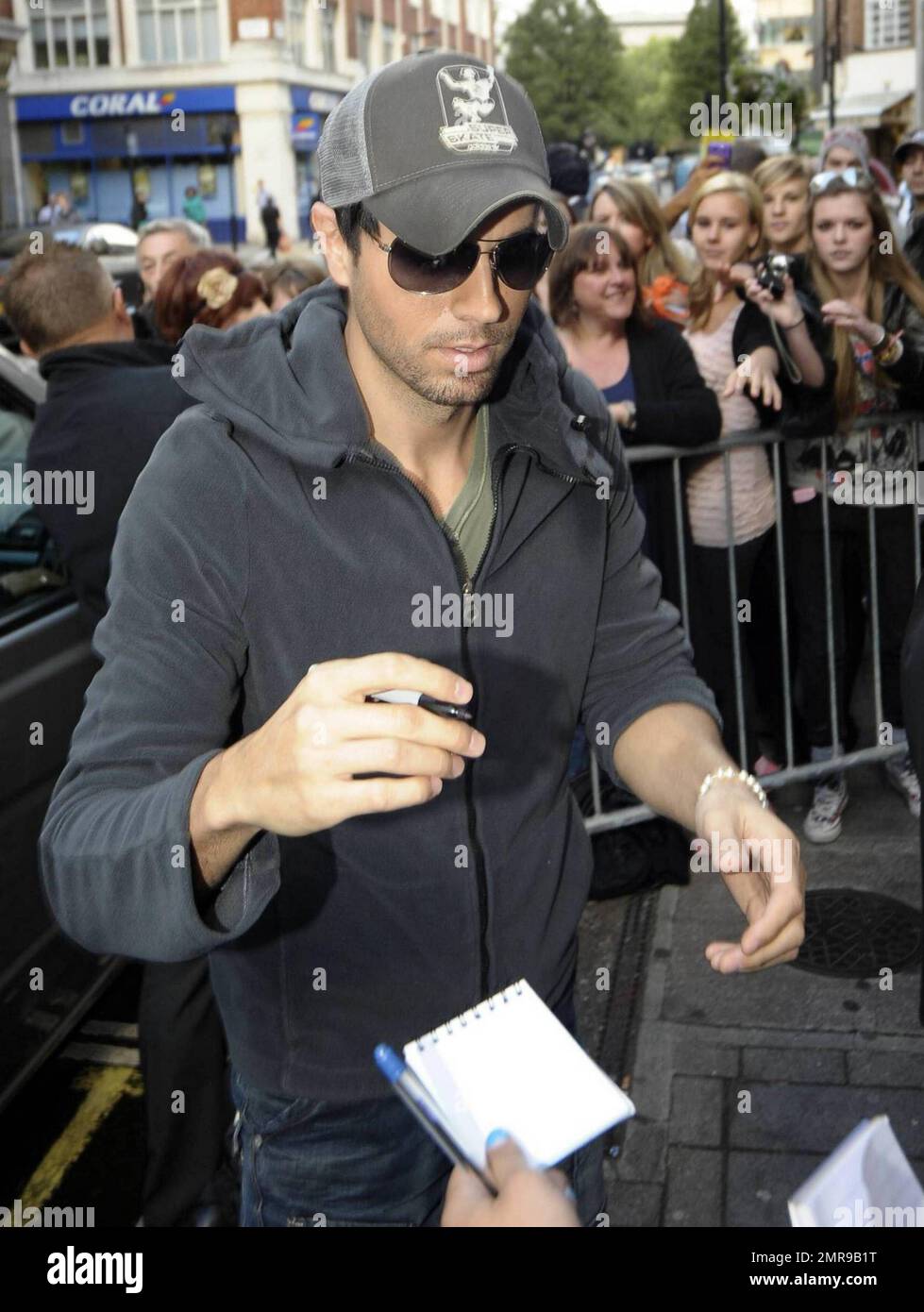 Enrique Iglesias greets fans on his way into the BBC studios. He signed ...
