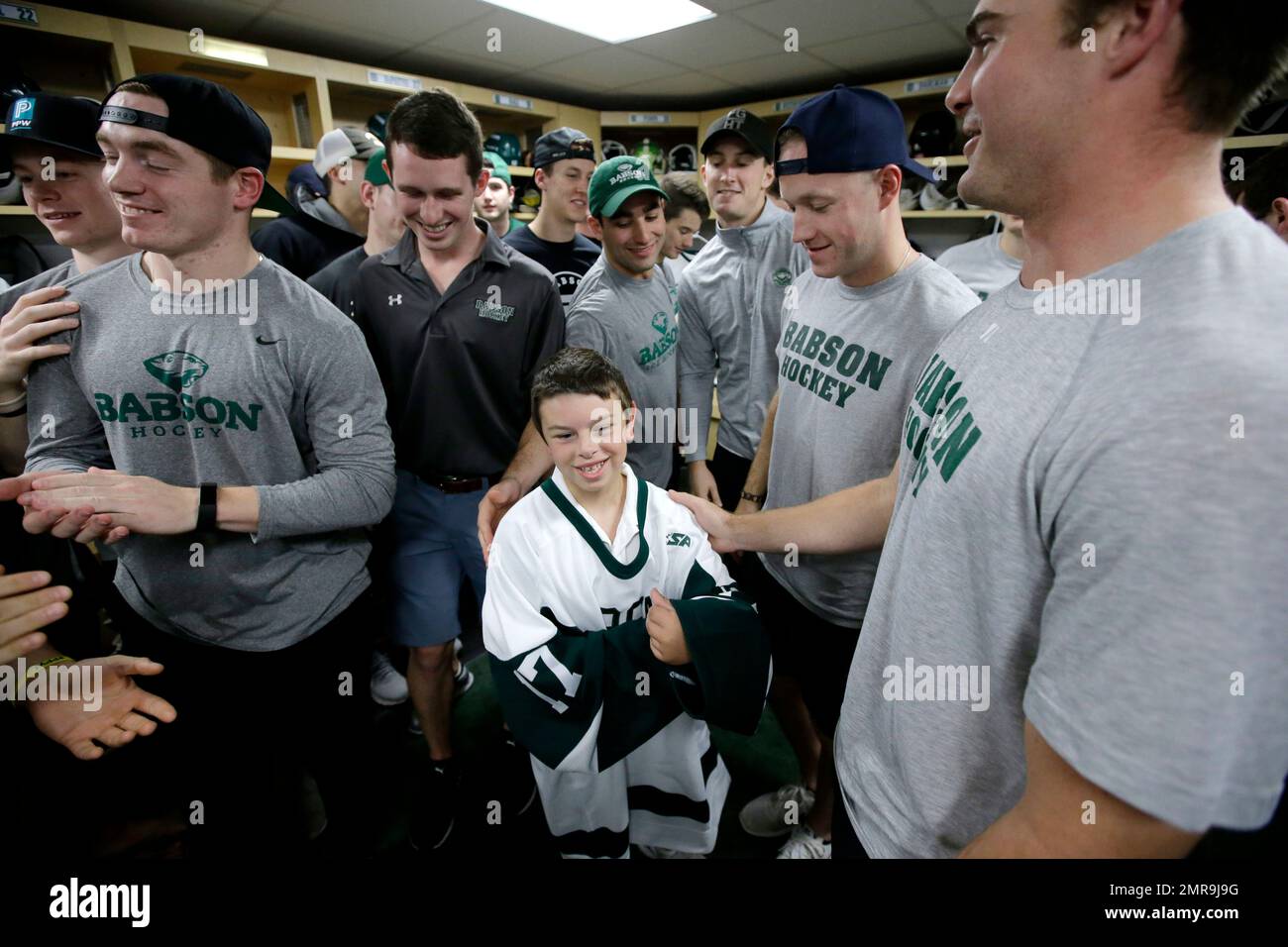 Coleman Walsh, 10, of Walpole, Mass., center, gathers with members the ...