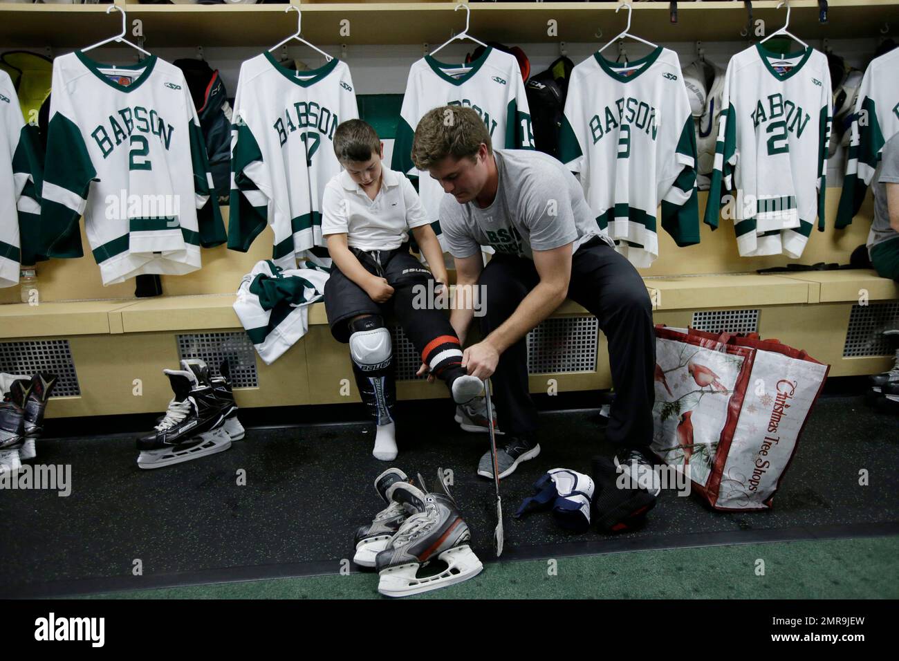 Coleman Walsh, 10, of Walpole, Mass., left, gears up with assistance ...