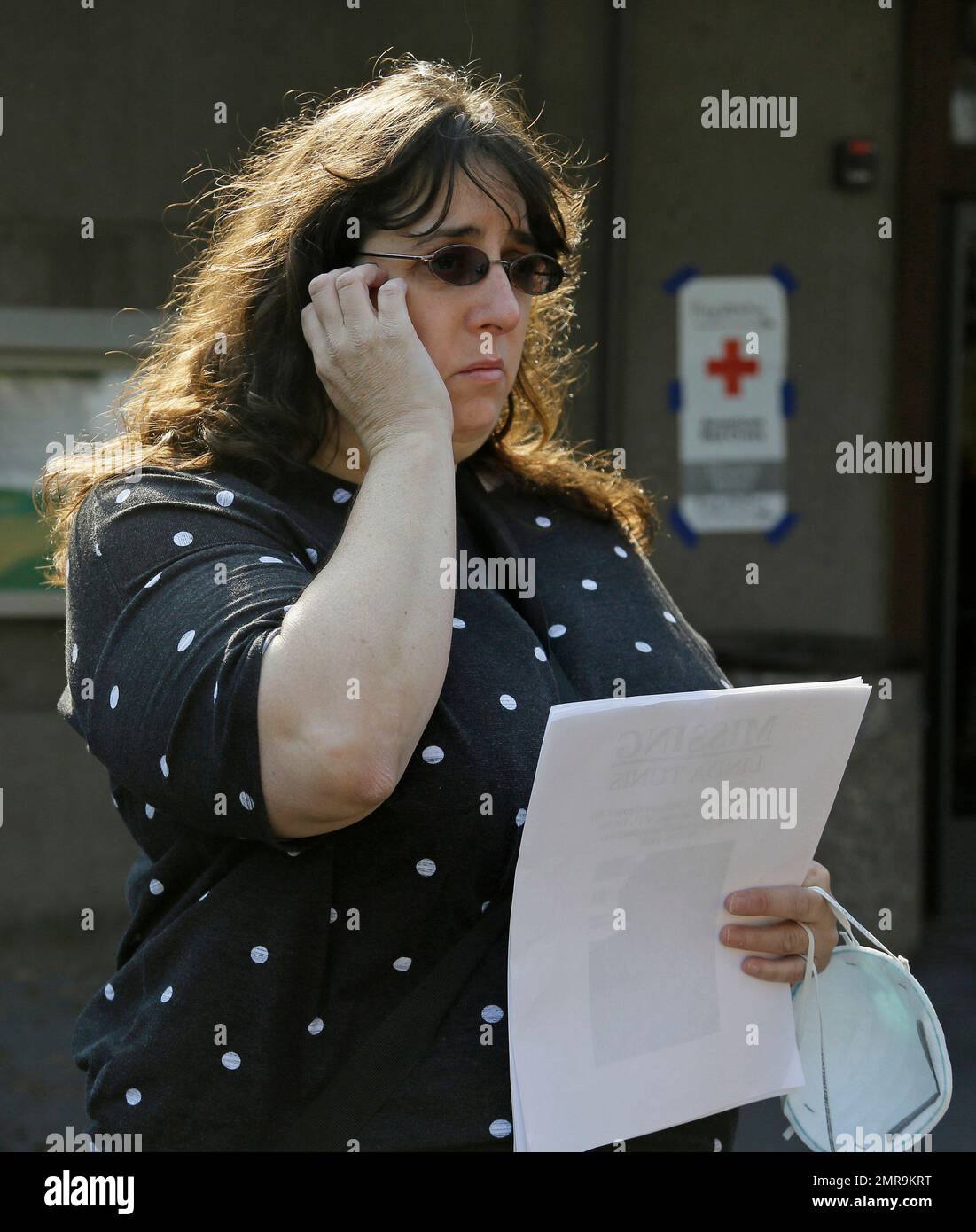 Jessica Tunis stands outside a Red Cross evacuation center and talks ...